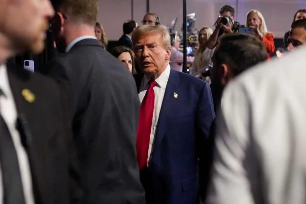 Trump makes rare spin room visit and suggests openness to a second debate