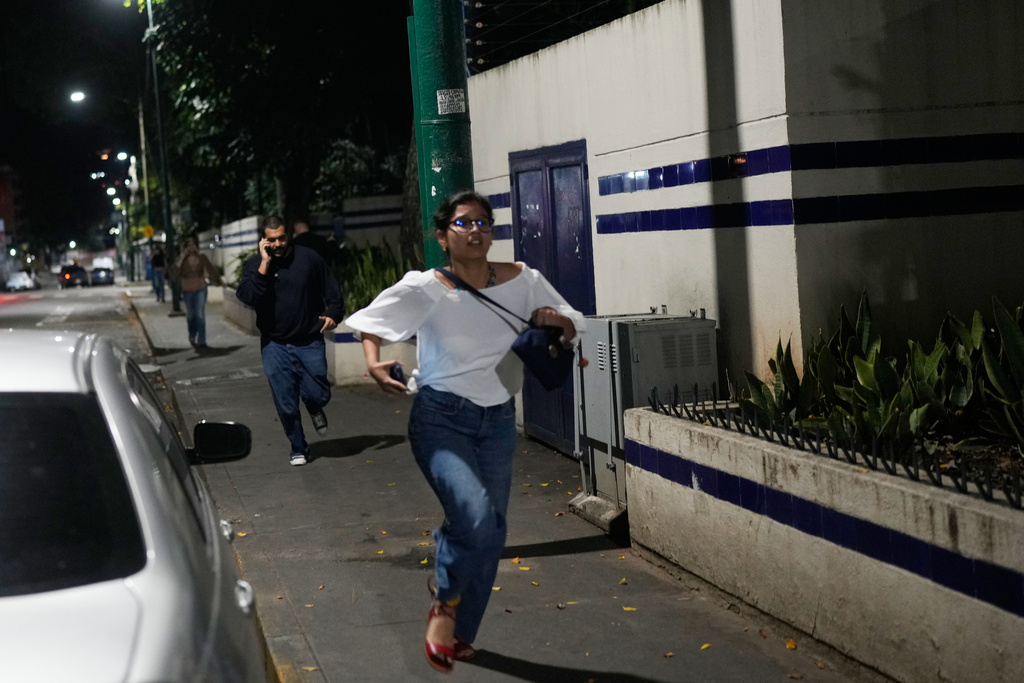 Pedestrians run after explosions and low-flying aircraft were heard in ...